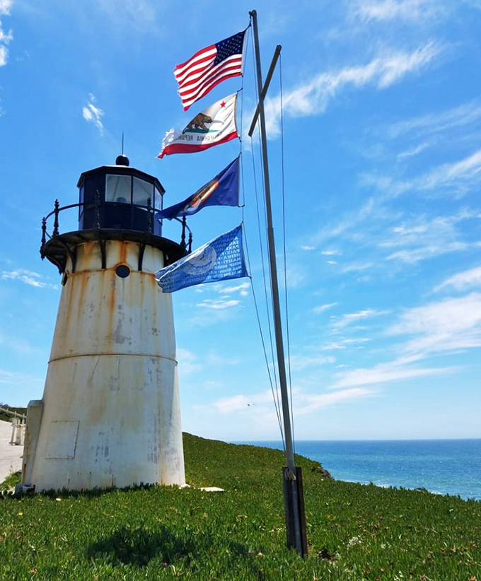 Flags flutter above this compact maritime guardian. At just 30 feet tall, what this lighthouse lacks in height, it makes up for in character and historical significance.