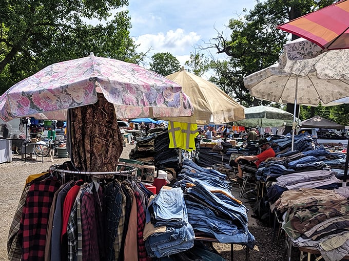Fashion archaeology at its finest! Layers of denim, flannel, and potential style statements await under colorful umbrellas.
