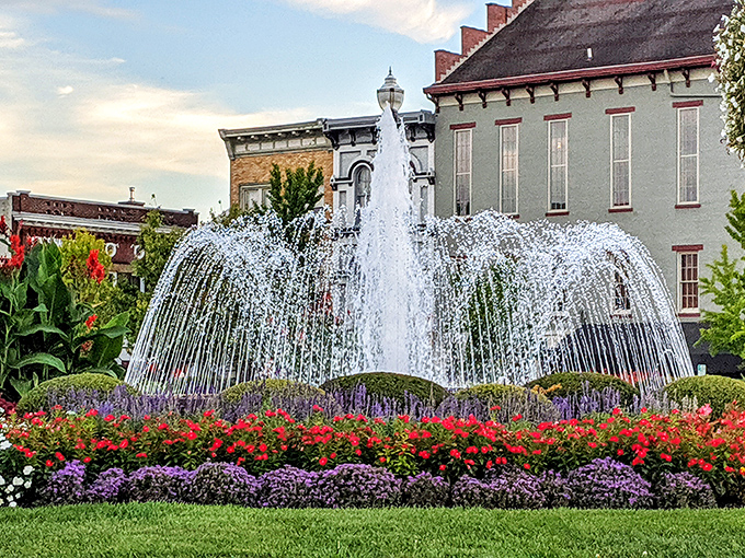 The downtown fountain creates a mesmerizing water ballet, surrounded by flowers so vibrant they look like they're competing for attention.