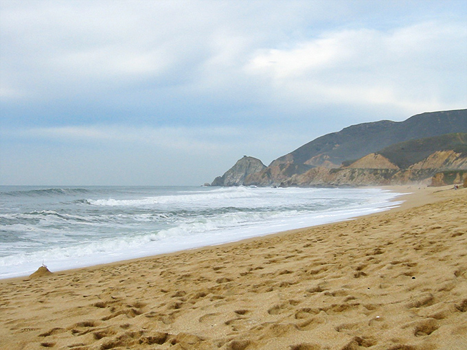 Mother Nature's sandbox stretches toward dramatic cliffs, where the rhythm of waves provides the soundtrack to daydreams and barefoot adventures.