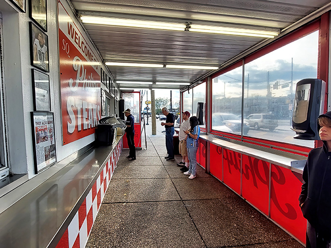 The line forms with purpose&mdash;locals and visitors united in pursuit of cheesesteak perfection under the no-frills covered walkway.