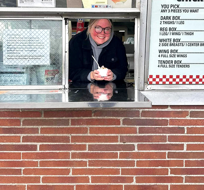 The friendly face behind the window proves that great chicken comes with even greater hospitality and warmth.