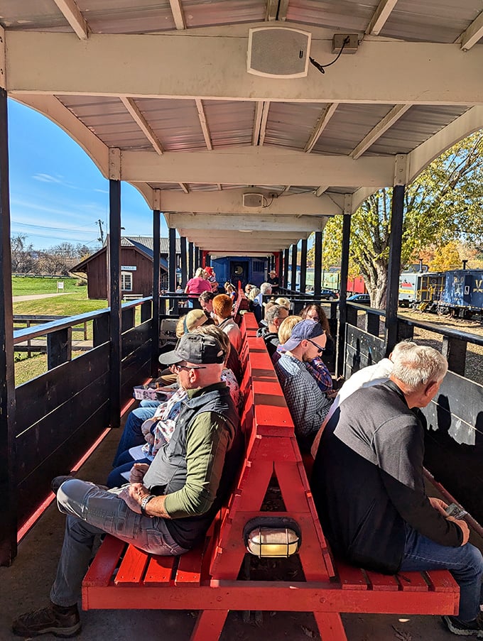 Passengers relax aboard an open-air railcar at the Nelsonville Depot, enjoying a sunny day and a ride through Ohio’s scenic railway history.