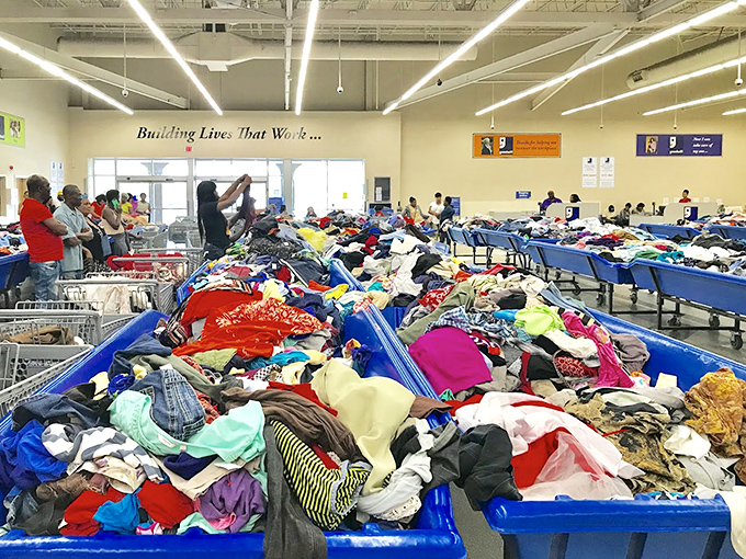 Mountains of possibility! Each blue bin contains potential fashion gold mines where yesterday's castoffs become tomorrow's statement pieces.