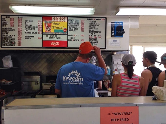 The kitchen crew works their magic behind the counter, where burger alchemy has been perfected over decades of dedicated craftsmanship.