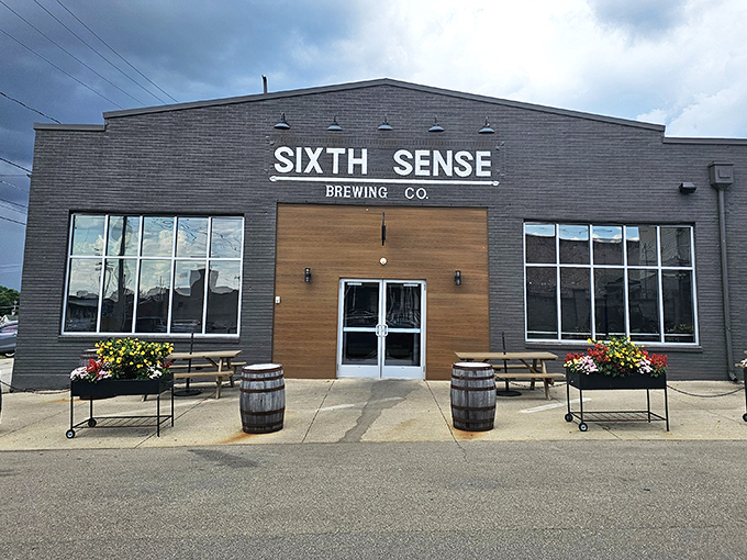 Sixth Sense Brewing welcomes beer lovers with rustic wooden doors and flower barrels, proving great craft beer doesn't need big city zip codes to find its audience.
