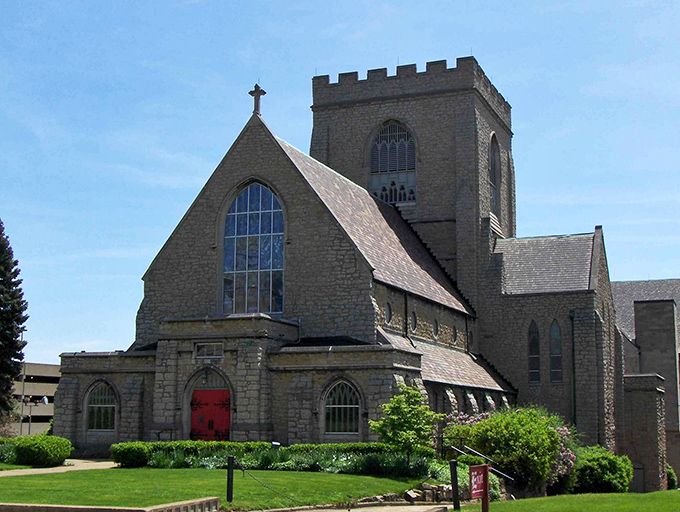 This isn't just a church; it's a stone symphony with that red door practically begging you to imagine all the weddings, funerals, and potluck dinners it's witnessed.