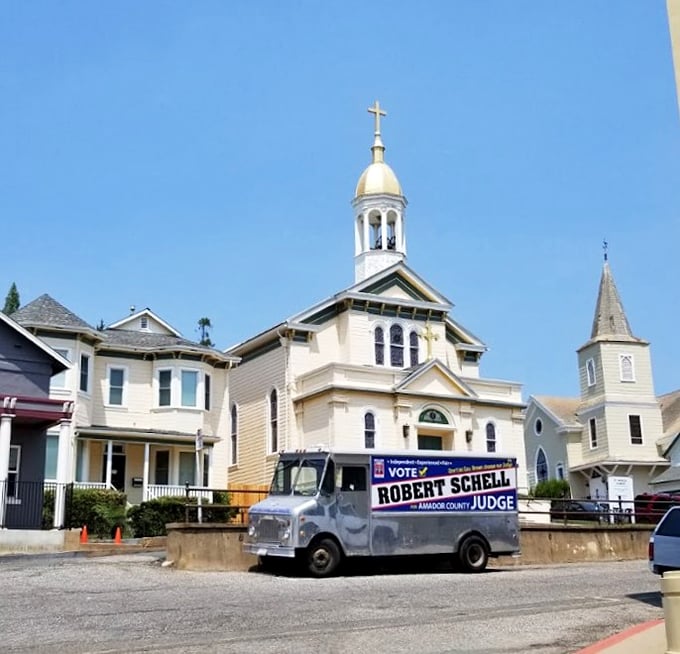 St. Patrick Catholic Church stands as a gleaming sentinel of faith, its white steeple reaching skyward like the hopes of Gold Rush dreamers who built this town.