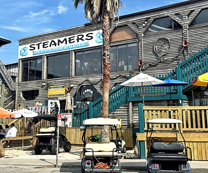 Steamers Clam Bar & Grill embodies Old Florida charm with its weathered wood exterior and inviting deck&mdash;golf carts included, because who needs a Ferrari here?