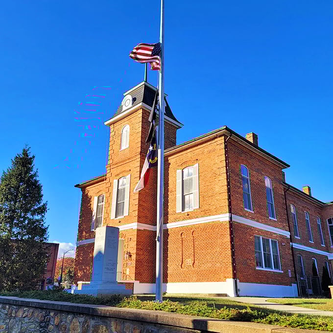 The historic Transylvania County Courthouse stands proudly under Carolina blue skies, its brick fa&ccedil;ade and clock tower a timeless anchor in downtown Brevard.