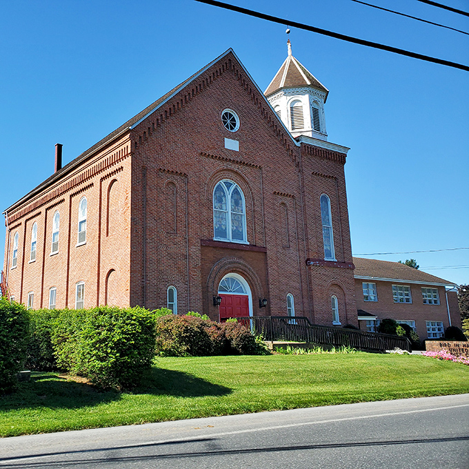 This stately brick church stands as a testament to simpler times, when architecture spoke volumes and Sunday best meant exactly that.