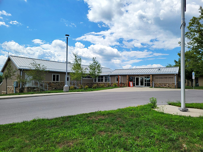 The park office welcomes visitors with its rustic stone-and-timber charm &ndash; nature's reception desk where adventures begin and maps mysteriously disappear from pockets. 