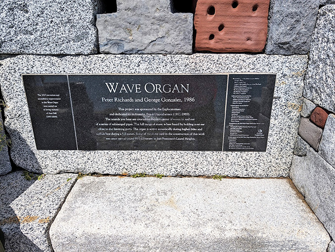 History etched in stone: The Wave Organ's plaque reveals its artistic origins while Alcatraz broods mysteriously in the distance.