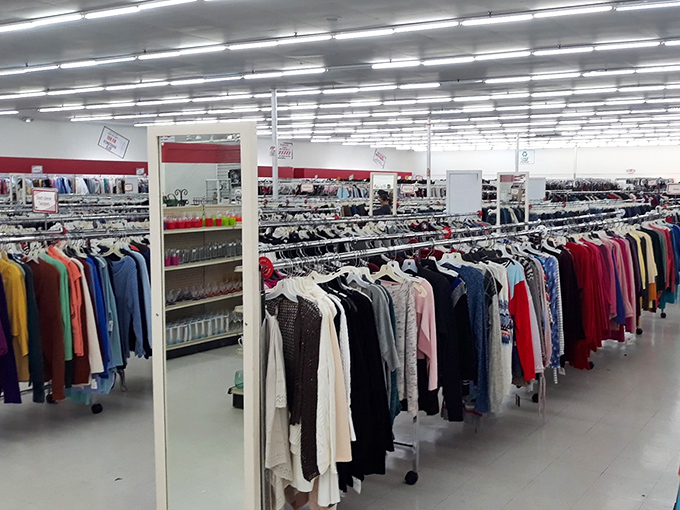 Rows upon rows of meticulously organized clothing create a textile rainbow that would make Marie Kondo weep with organizational joy.