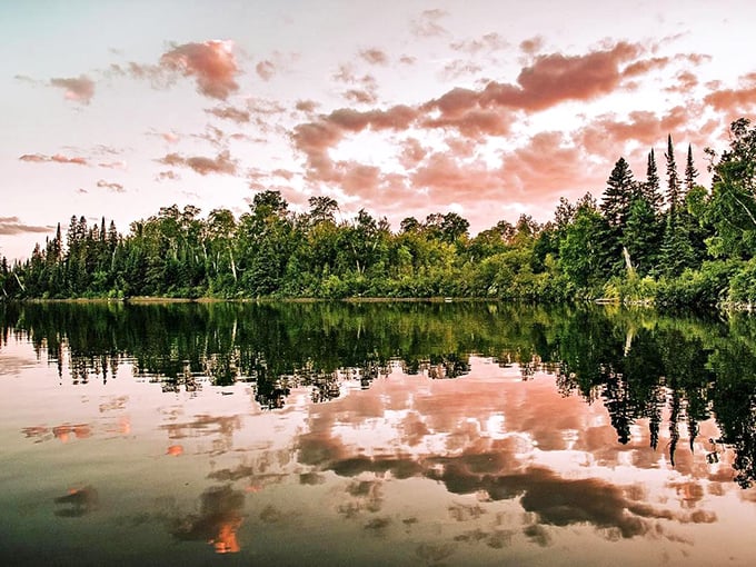 Sunset paints the sky in cotton candy hues, creating a mirror image on waters so still you'd think Mother Nature hired a professional photographer.