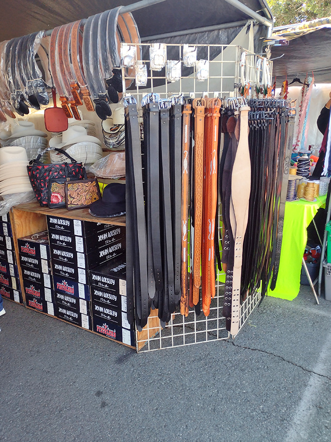 Leather belts hang like a cowboy's wardrobe explosion, each one waiting to cinch your next great deal.