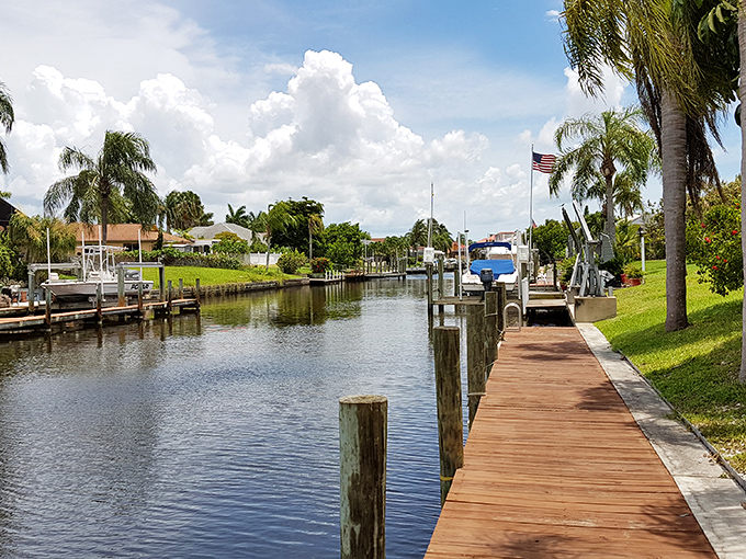 Morning strolls take on new meaning when your sidewalk is a dock. This peaceful canal scene is the everyday reality for Cape Coral residents.