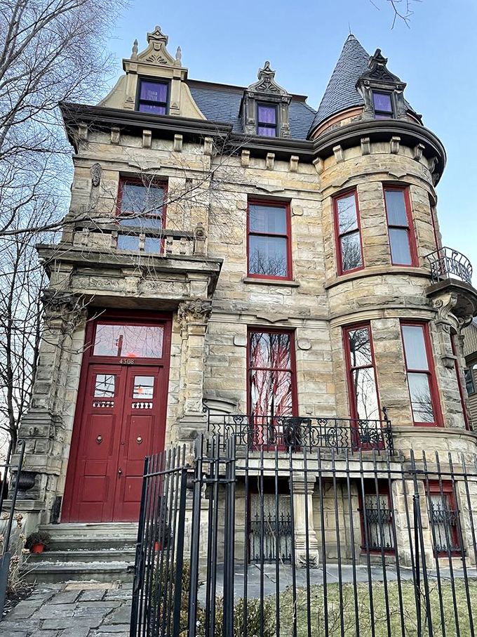Those crimson doors aren't just an entrance &ndash; they're a portal to another time. The contrast against the sandstone exterior practically screams "haunted mansion."