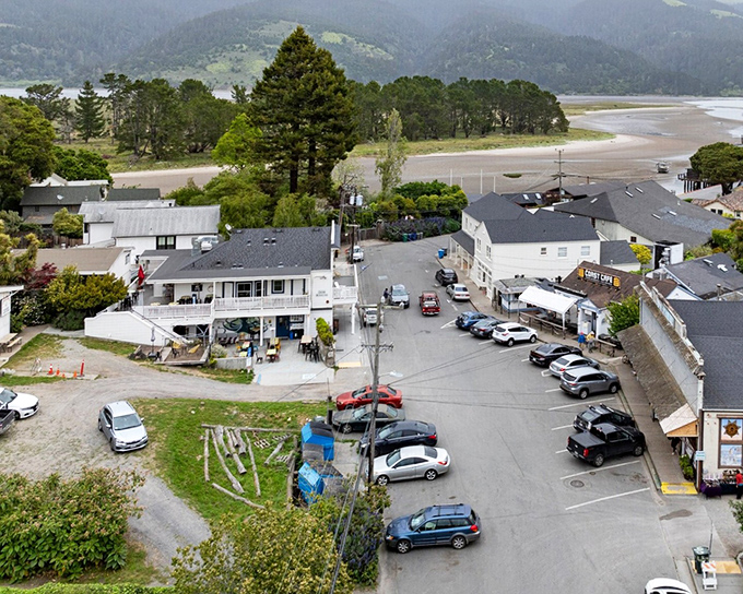 Bolinas from above &ndash; a patchwork of weathered rooftops and hidden gardens nestled between mountain and sea. The town's reluctant postcard view.