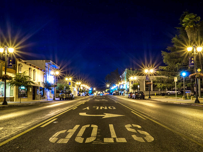 Main Street after dark transforms into a magical small-town tableau where even the "STOP" looks like an invitation to stay awhile.