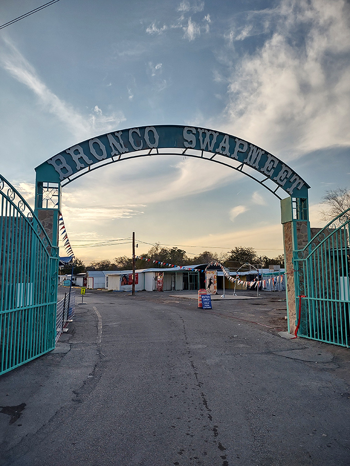 The iconic teal arch stands like a portal to retail adventure. Morning light bathes the entrance, while early birds strategize their treasure-hunting routes.