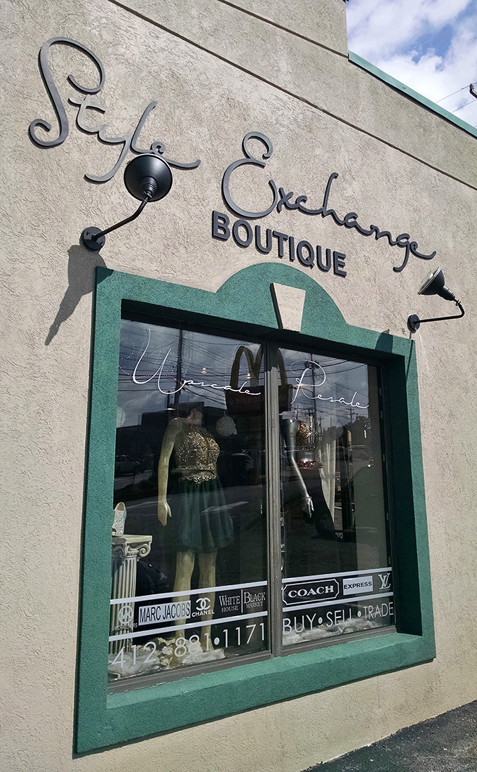 The elegant script of Style Exchange Boutique's storefront promises fashion treasures within, with designer names proudly displayed in the window.