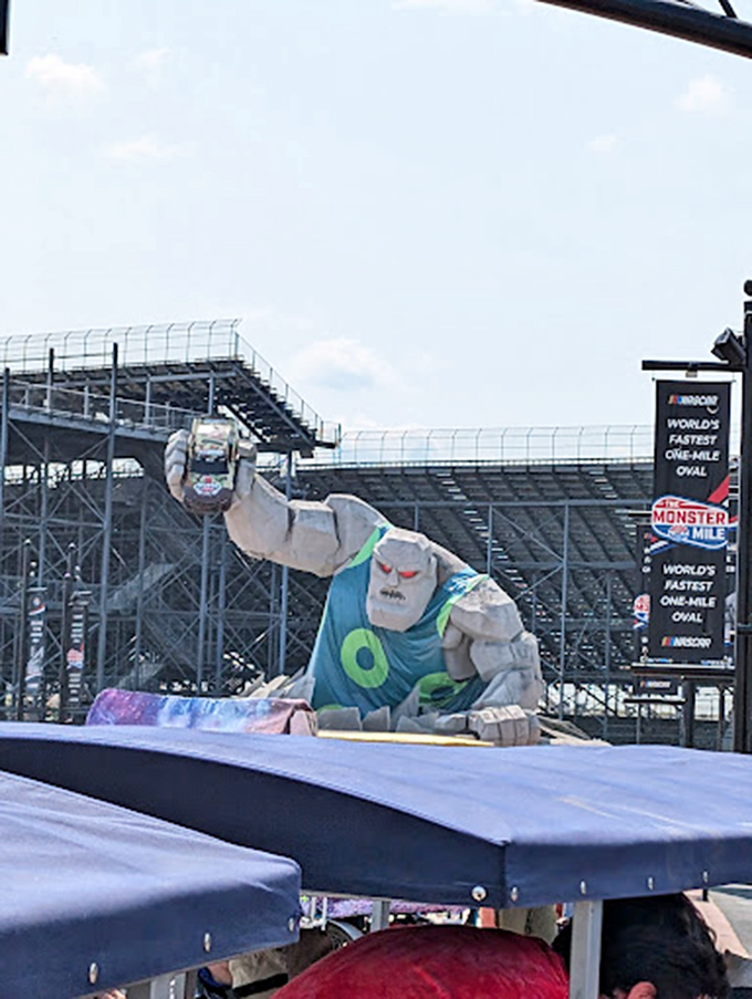 Even monsters need a wardrobe change! Miles sports a festive blue tank top, proving that 46 feet of concrete can still make fashion statements.