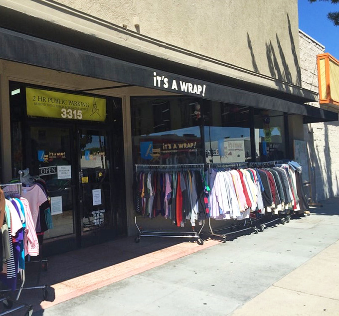 Racks spill onto the sidewalk like a red carpet invitation, beckoning passersby to browse pieces of Hollywood history at surprisingly accessible prices.