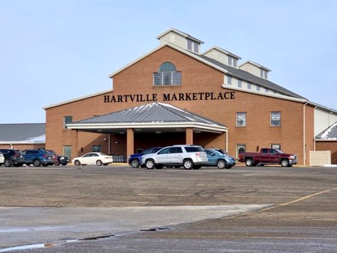 The brick facade of Hartville Marketplace stands like a temple to retail therapy, promising adventures in bargain hunting behind those doors.
