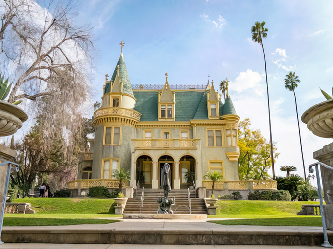 Honey, I found our next vacation home! The château-style mansion basks in California sunshine, its teal roof and cream façade creating a perfect postcard moment.