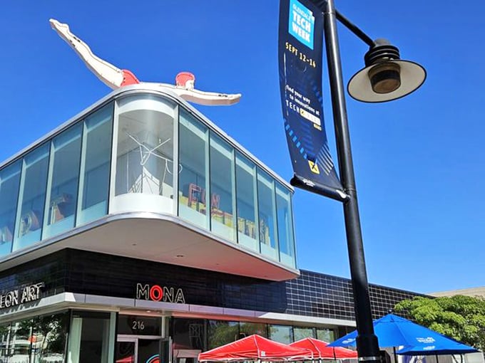 The iconic red diver perched atop MONA serves as both landmark and metaphor&mdash;inviting visitors to take the plunge into a sea of neon wonders.