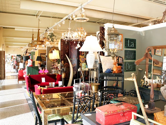 Chandeliers that have witnessed a thousand dinner parties hang like crystalline sentinels above an eclectic mix of vintage furnishings and modern treasures.