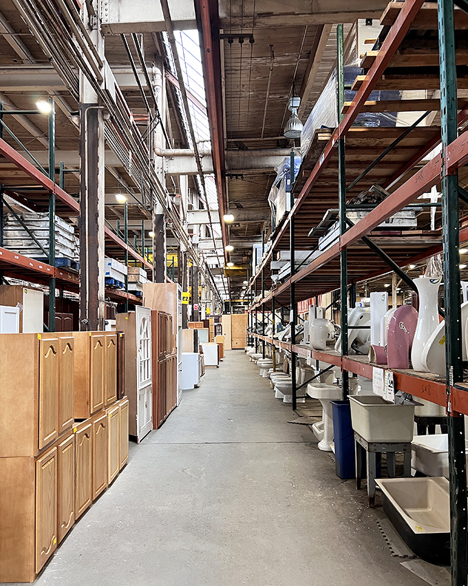 Aisles stretch toward infinity like a home improvement fever dream. Bathroom fixtures and cabinets stand at attention, awaiting their second act.
