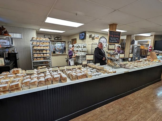 Bread heaven exists, and I've found it. The counter stretches like a carbohydrate runway, showcasing loaves that make grocery store bread look like sad impostors.
