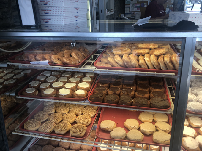 Step into donut heaven where fluorescent lights illuminate treasures that would make Willy Wonka weep with joy.