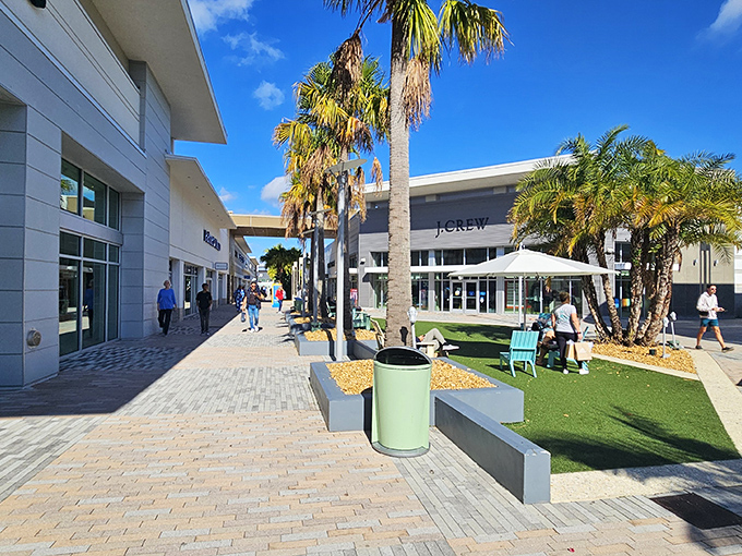 Palm trees stand sentinel along pristine walkways, creating tropical retail oases between stores where shoppers catch their breath before the next discount adventure.