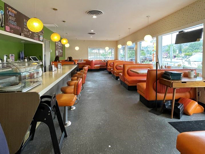 Those glorious orange booths aren't trying to be retro-chic—they're the real deal, silently witnessing decades of first dates and family celebrations.