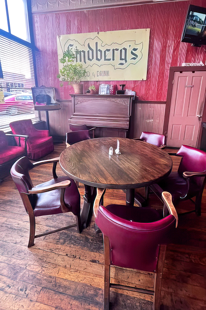 The soul of Springfield lives in these burgundy chairs and worn wooden floors, where conversations flow as smoothly as the drinks.
