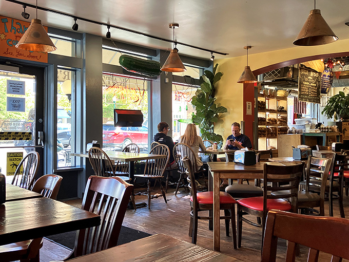 Inside Katzinger's, time slows down as sunlight streams through windows, illuminating a space where sandwich magic has happened daily since 1984.