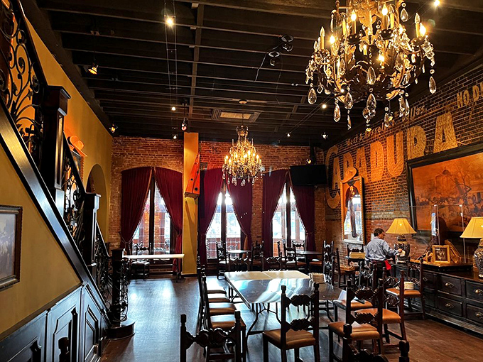 Crystal chandeliers meet exposed brick walls in this dining room where elegance and comfort coexist like old friends sharing a margarita.