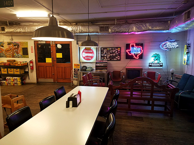 Neon signs cast a warm glow over wooden tables where burger dreams come true. That Texas-shaped light isn't subtle, but neither is the flavor.