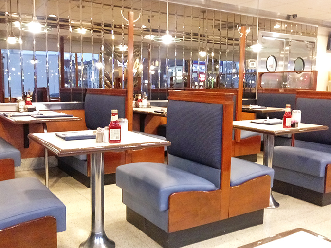 Blue booths, chrome accents, and mirrored walls&mdash;this isn't retro cosplay, it's the real deal of American diner authenticity.