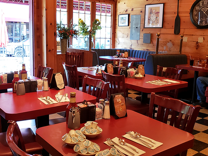 Warm wood paneling and classic red tables create that rare atmosphere where you instantly feel like a regular, even on your first visit.