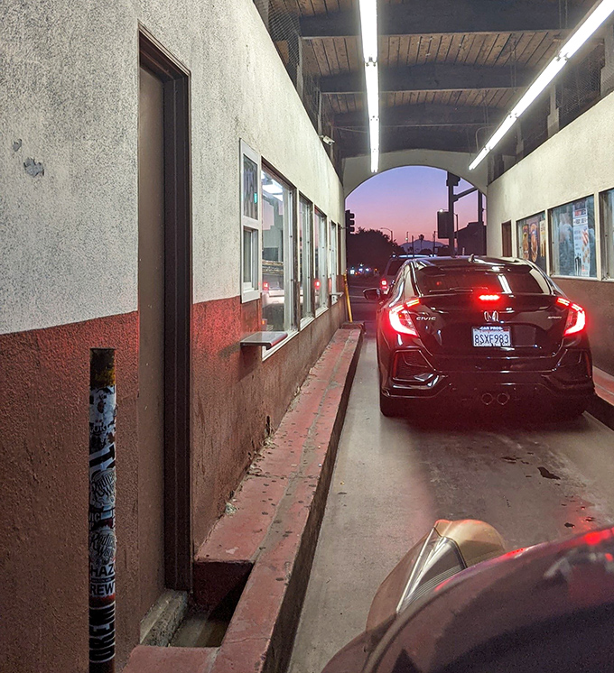 Twilight at the tunnel of treats. Cars line up for their sweet fix as day turns to dusk, creating a uniquely SoCal donut pilgrimage.