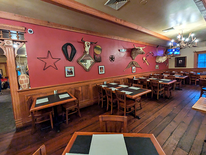 Western heritage adorns these red walls where longhorn skulls and rustic stars create an atmosphere that whispers, "Settle in, pardner. You're about to eat well."