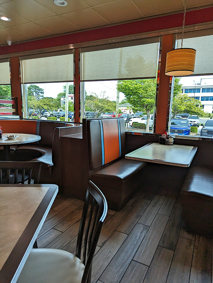 Classic diner booths with their distinctive orange stripes invite you to slide in, settle down, and prepare for a feast that transcends time.