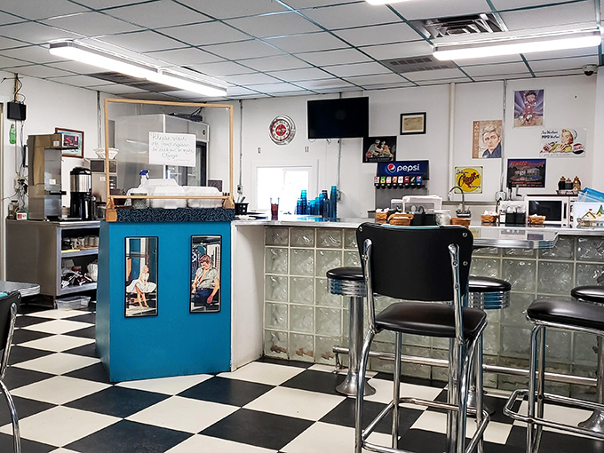 Step inside and the classic black-and-white checkered floor announces you've arrived somewhere special, where blue accents and counter seating create the quintessential American diner experience.