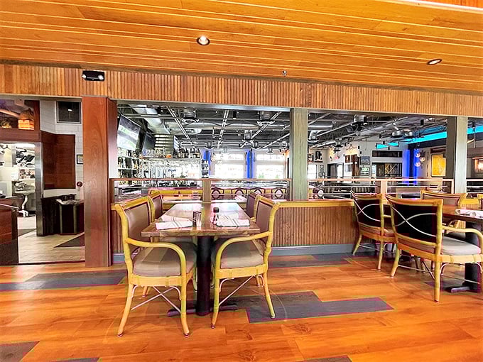 Warm wooden tones and nautical-inspired design create an atmosphere that whispers "coastal retreat" rather than shouting "theme restaurant."