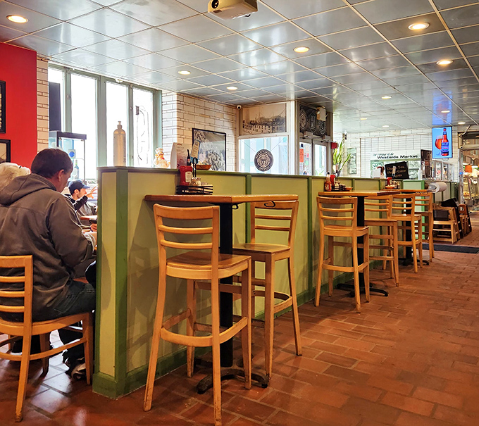 Counter seating that invites solo diners to become regulars, where green dividers create little islands of culinary contentment.