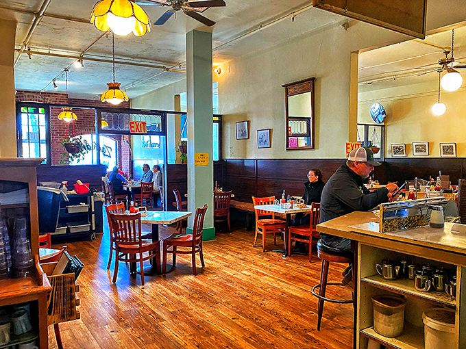 Warm yellow walls, vintage pendant lights, and well-worn wooden floors create the perfect backdrop for morning conversations that flow as freely as the coffee. 